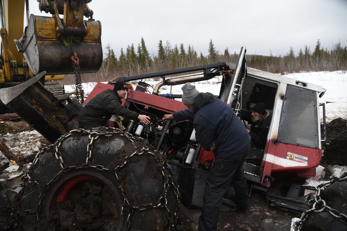 Workers pull logging vehicle from Portage Lake